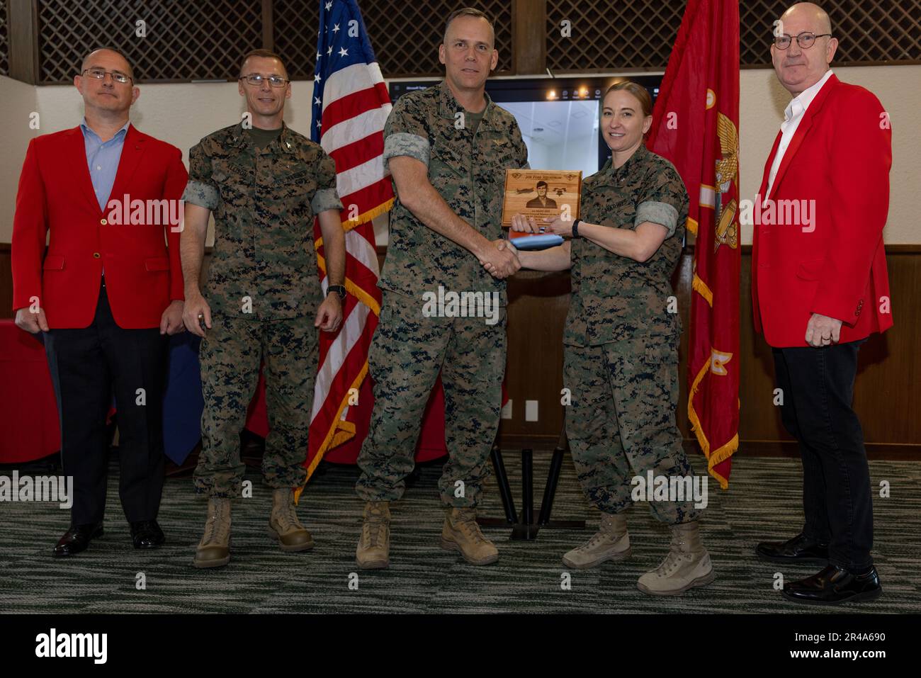 U.S. Marine Corps Lt. Col. Nicole Penn accepts a plaque on behalf of ...