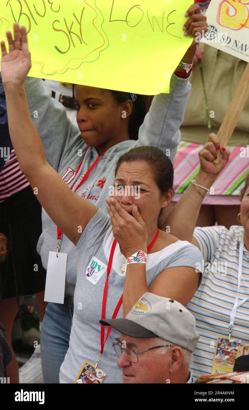 US Navy Family and friends await the arrival of their loved ones aboard ...