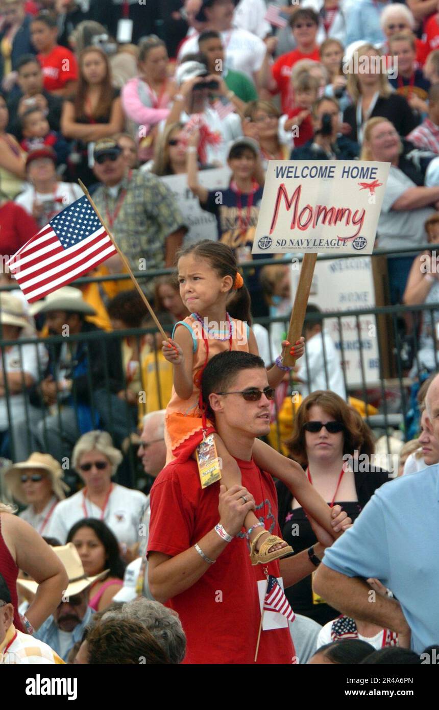 US Navy Family and friends anxiously wait at pier facilities on board ...