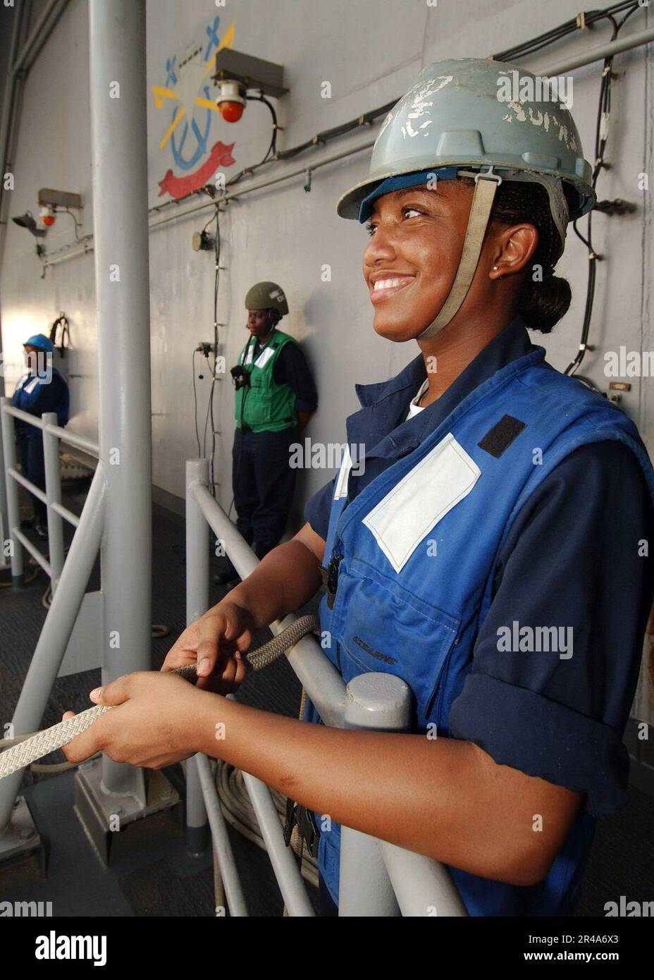 US Navy A Sailor mans a forward tending line on the starboard boat ...