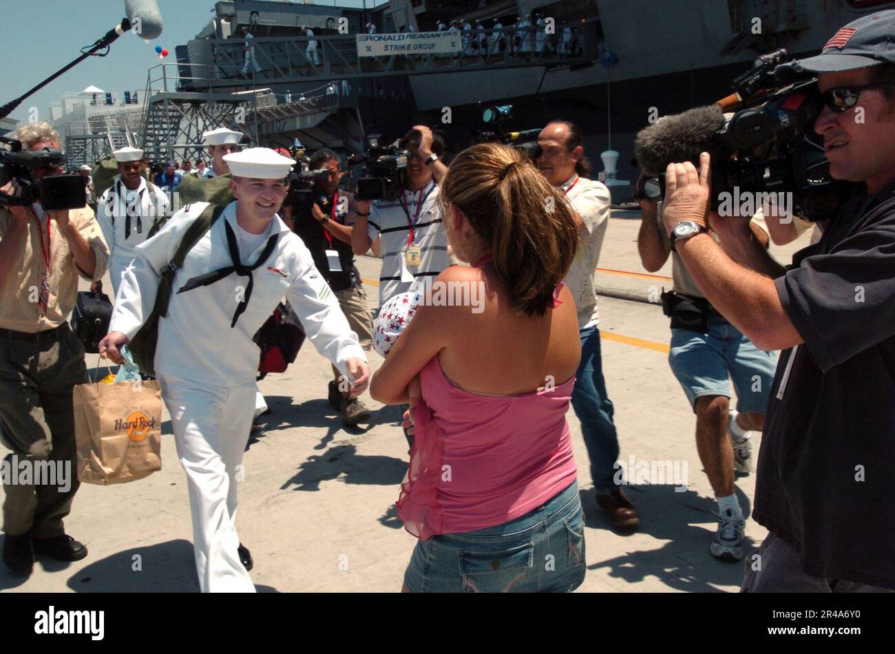 US Navy A Sailor greets his loved after departing USS Ronald Reagan ...