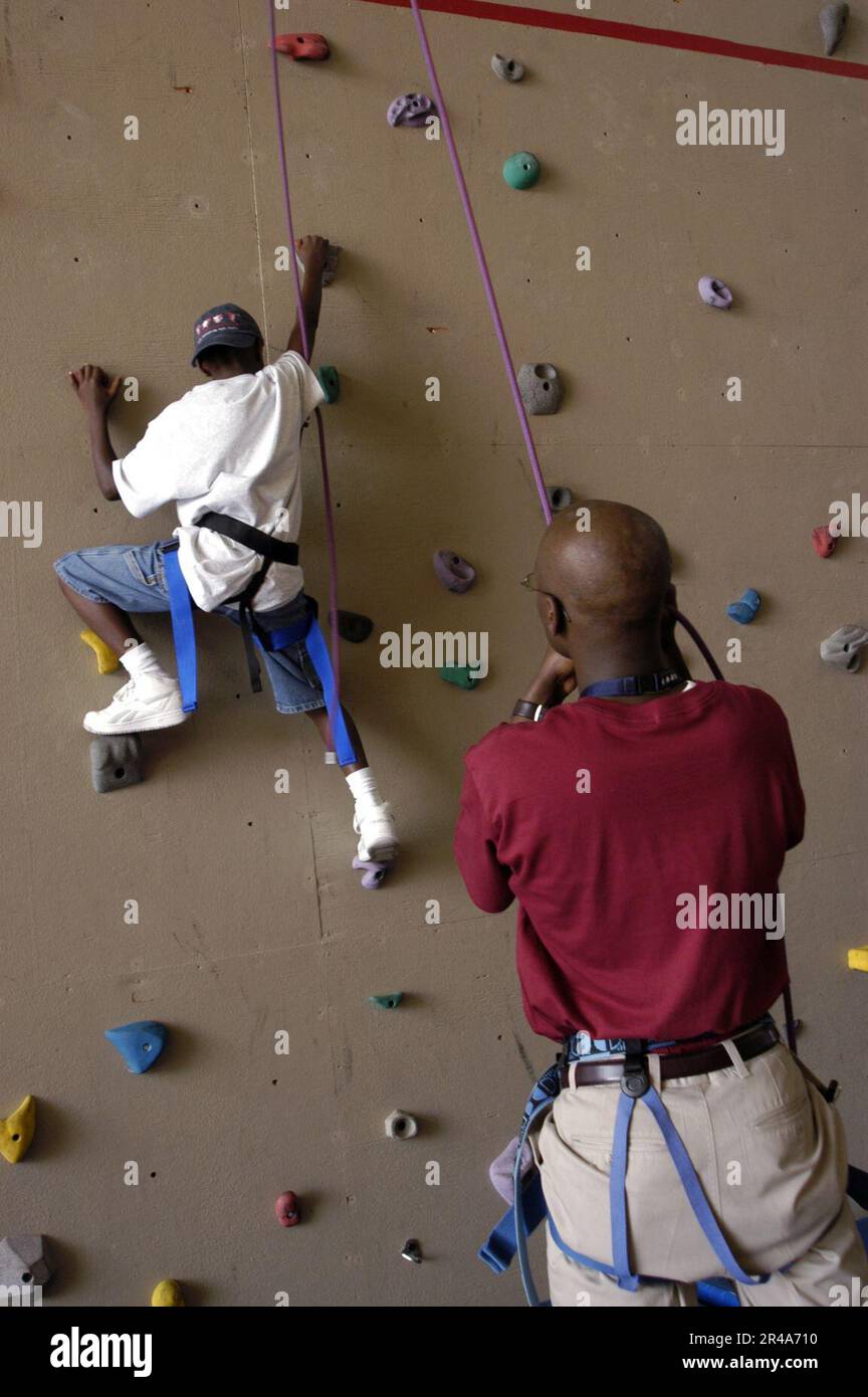 US Navy Yeoman 1st Class assists his son up the rock-wall at the Smoky ...