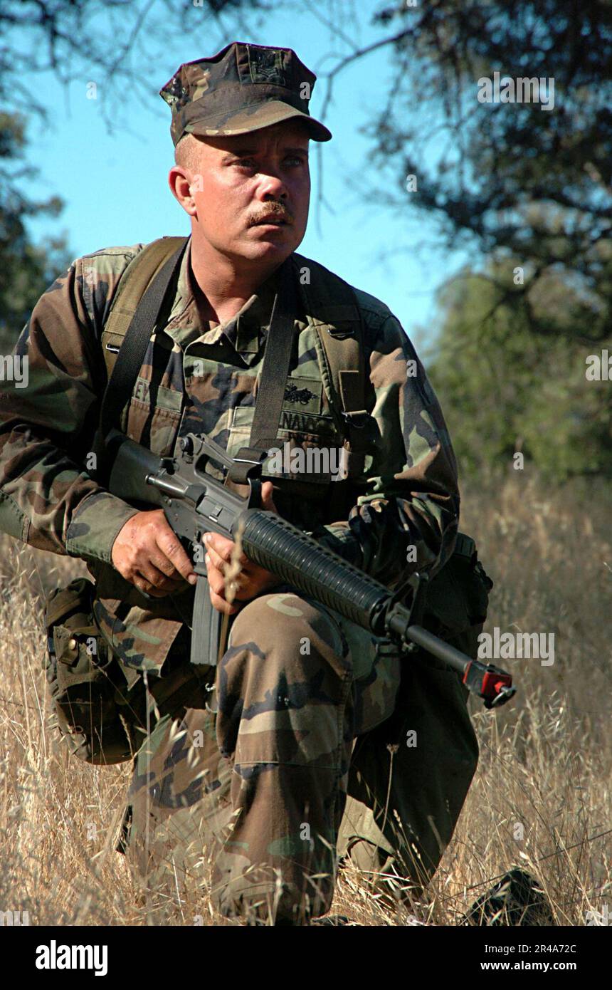 US Navy Builder 1st Class watches for aggressing forces on a squad ...