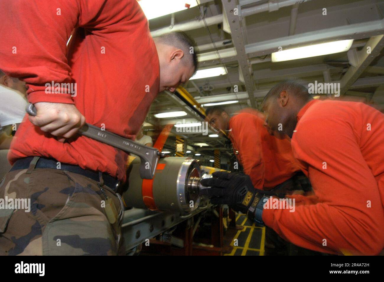US Navy Aviation Ordnancemen torque the retainer ring of a MK-82 500lb ...