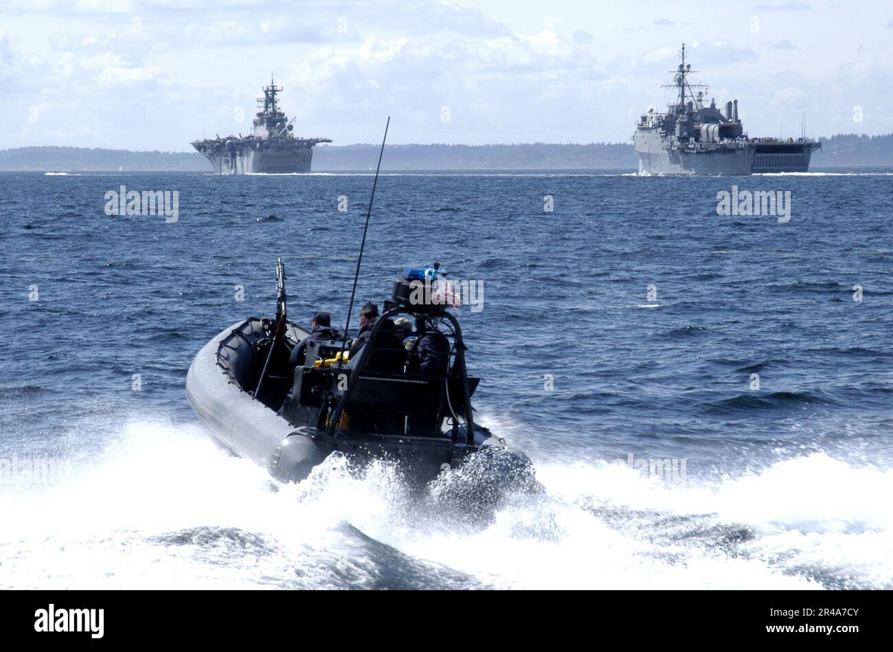 US Navy A Coast Guard patrol boat cruises the surrounding waters while ...