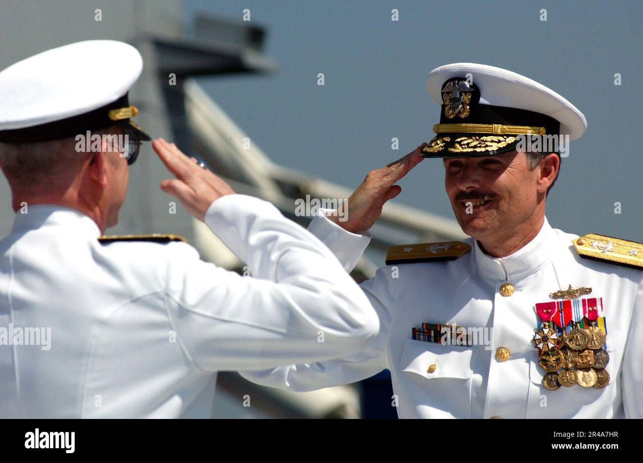 US Navy Rear Adm. Robert J. Cox, right, returns a salute to Rear Adm ...