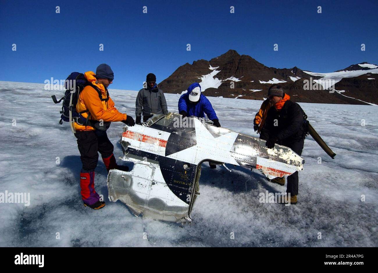 US Navy Recovery personnel examine the wreckage of a Navy P-2-V Neptune ...