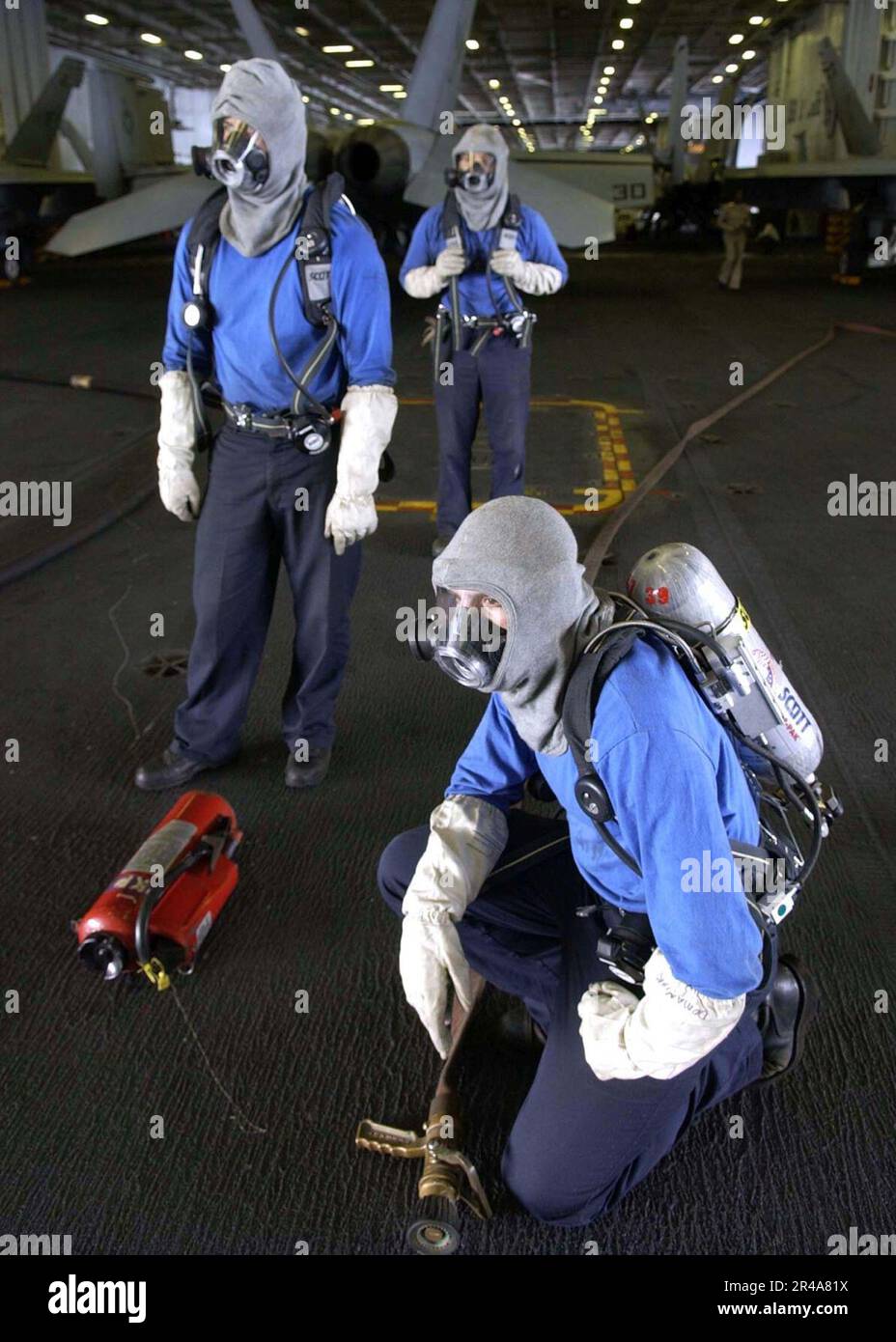 US Navy Sailors assigned to a fire fighting party aboard the aircraft ...