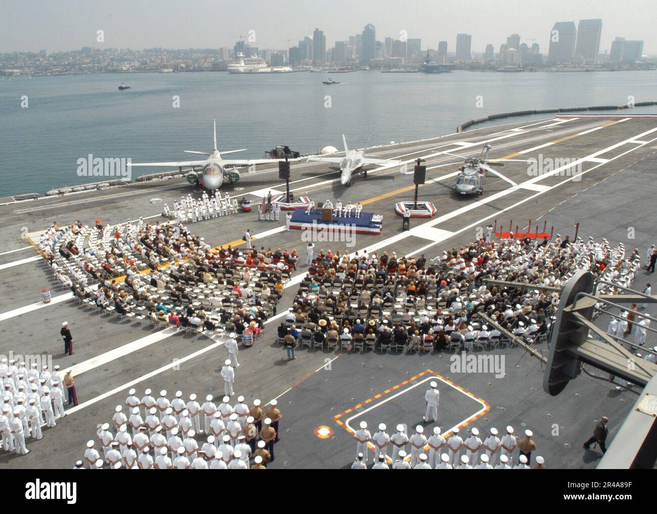 US Navy Officers, crew, distinguished guests and family members listen ...