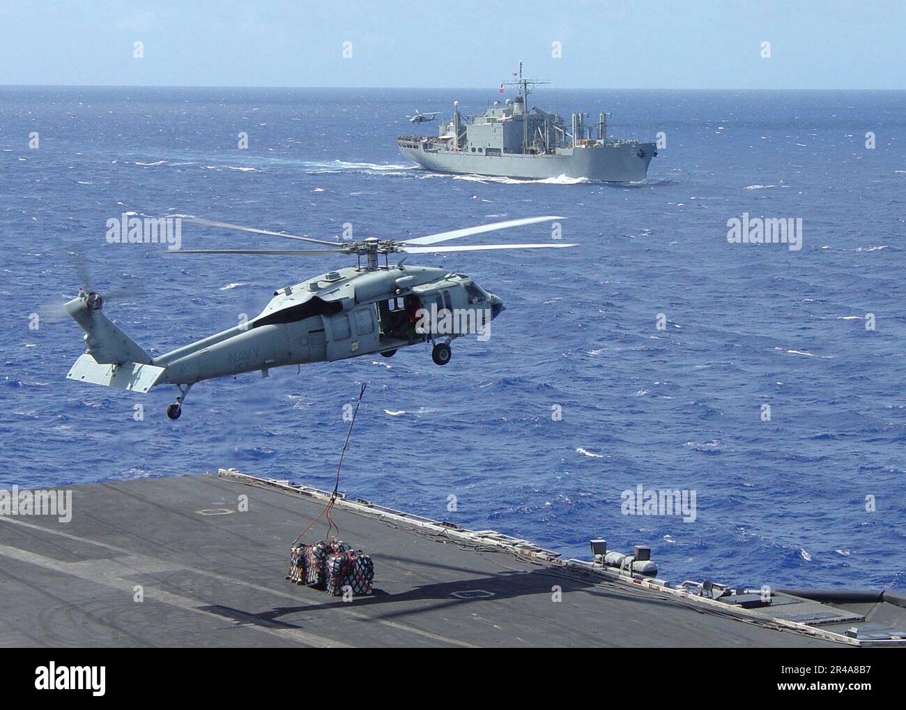 US Navy A MH-60S Knighthawk transports supplies from the Military ...