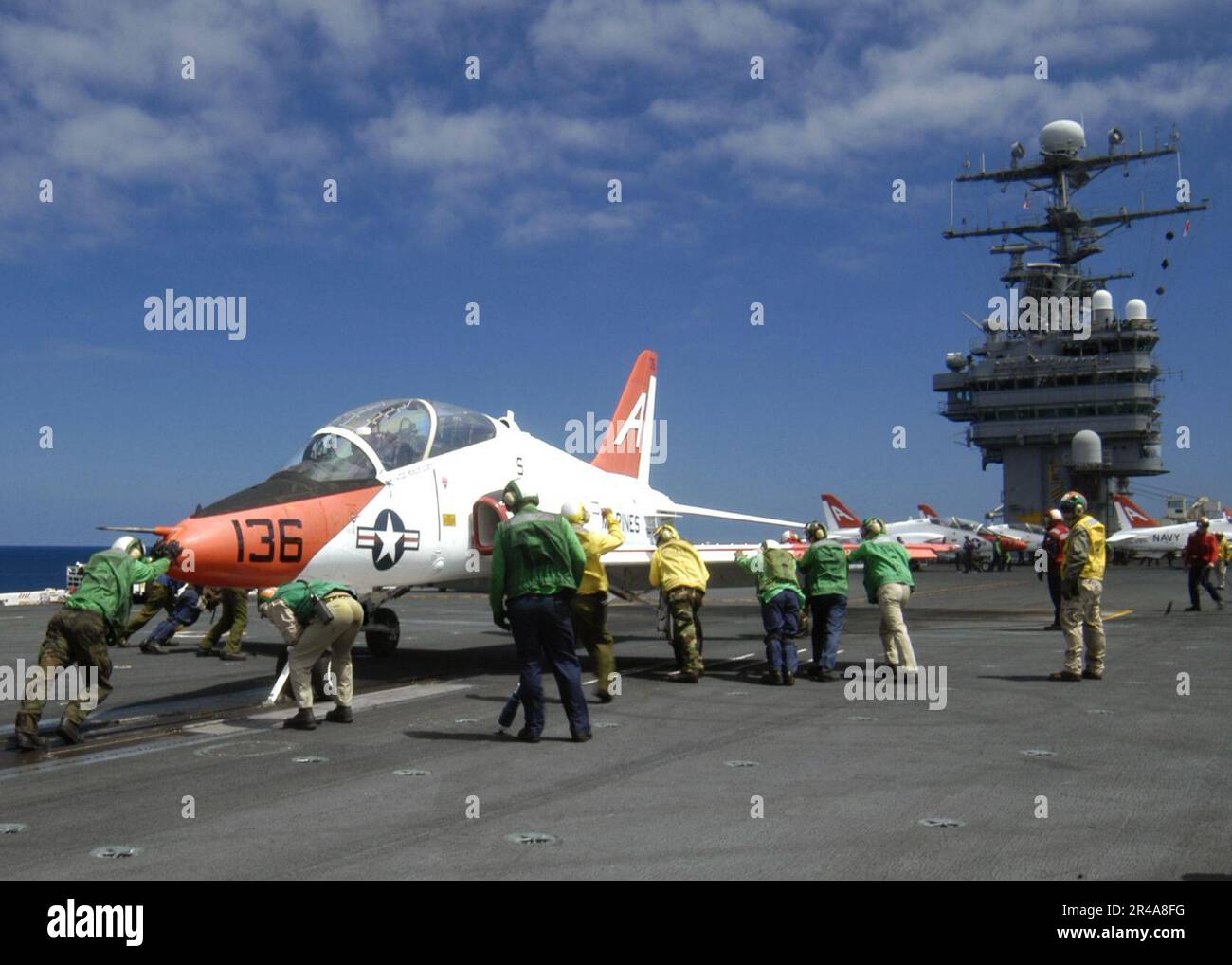 US Navy Flight deck personal perform a PUSH BACK on a T-45A Goshawk ...
