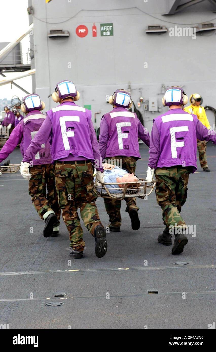 US Navy Crew members participate in a mass casualty drill aboard the ...