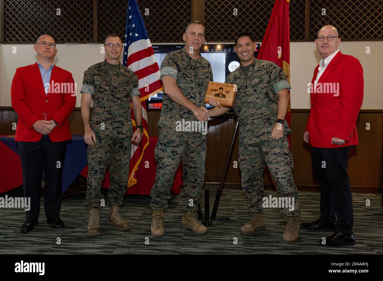 U.S. Marine Corps Maj. Scott Caton accepts a plaque on behalf of Capt ...