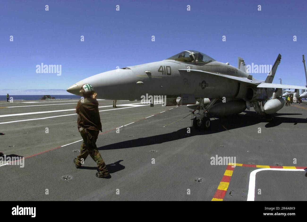 US Navy A plane captain prepares an F-A-18C Hornet assigned to Strike ...