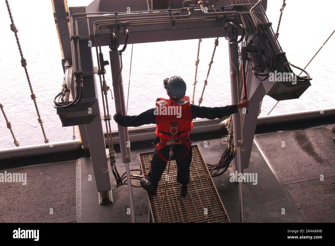 US Navy Holding on to the emergency brake and strapped in to a harness ...