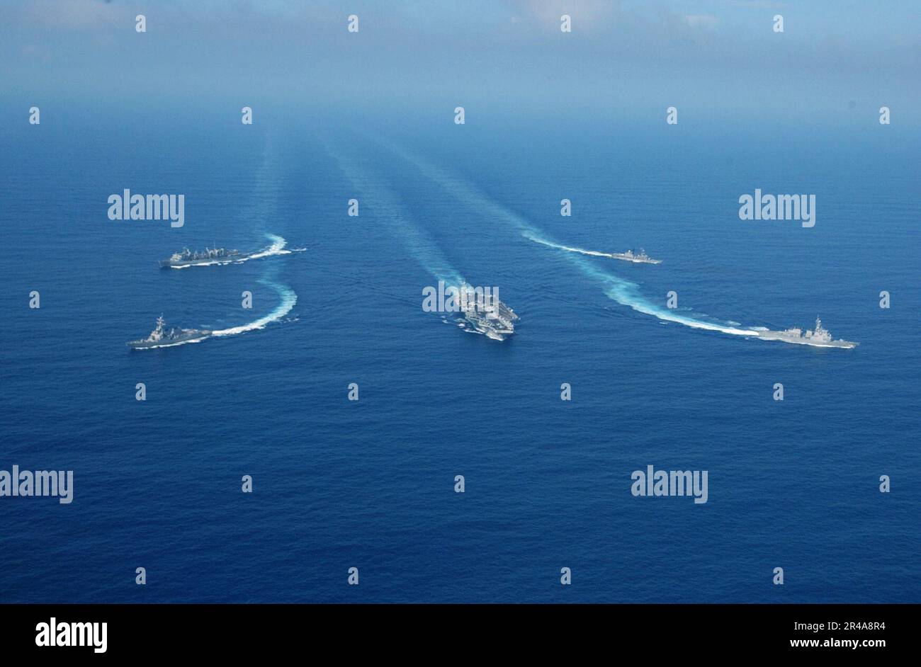 US Navy The Nimitz-class aircraft carrier USS John C. Stennis (CVN 74) steams in formation Stock ...