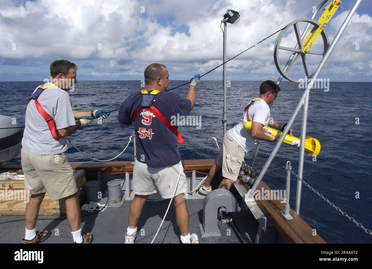 US Navy Staff archeologist Frank Cantelas, left, and crew aboard the ...