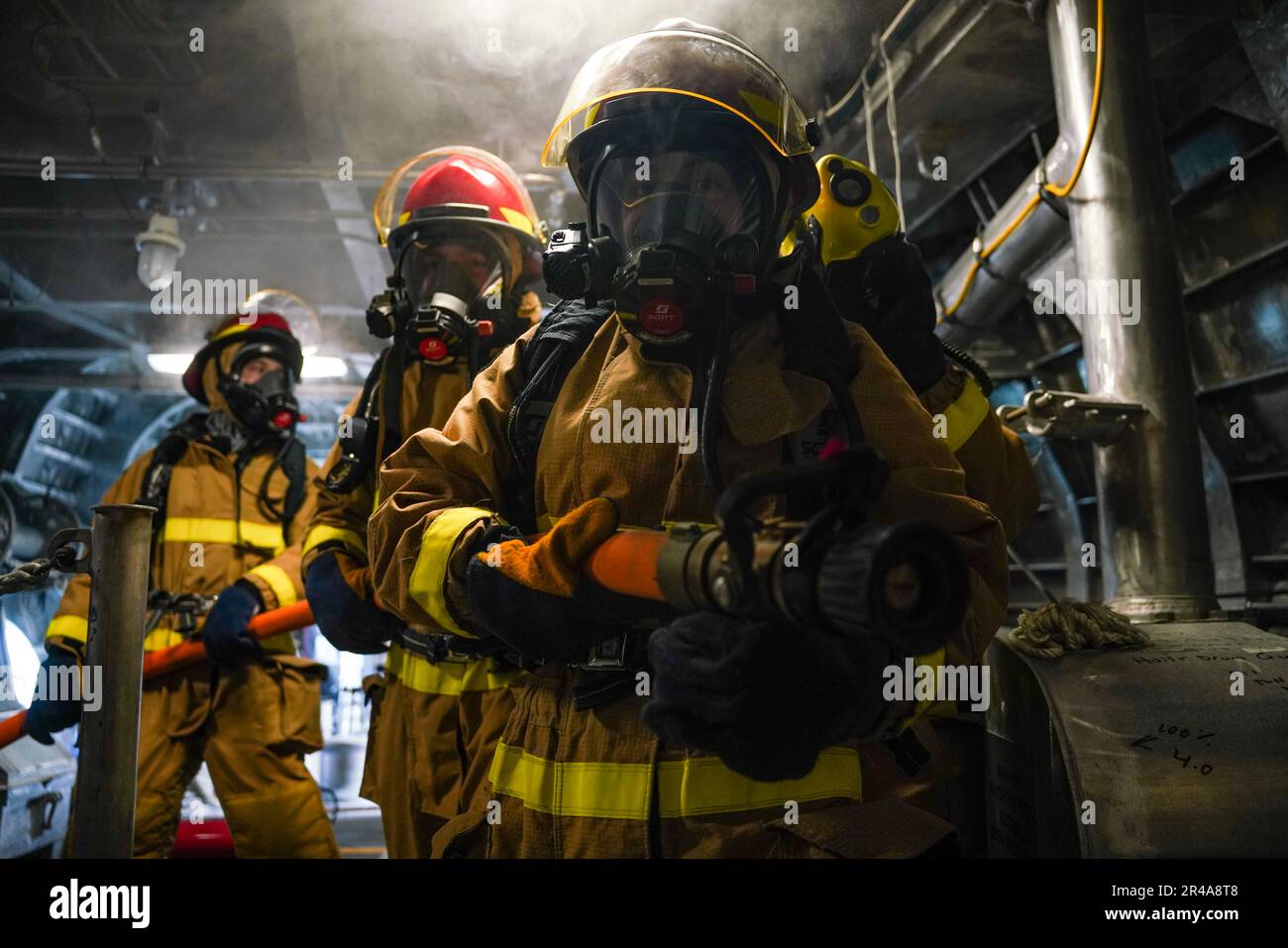 SINGAPORE (March 15, 2023) Sailors operate a firehose during a damage ...