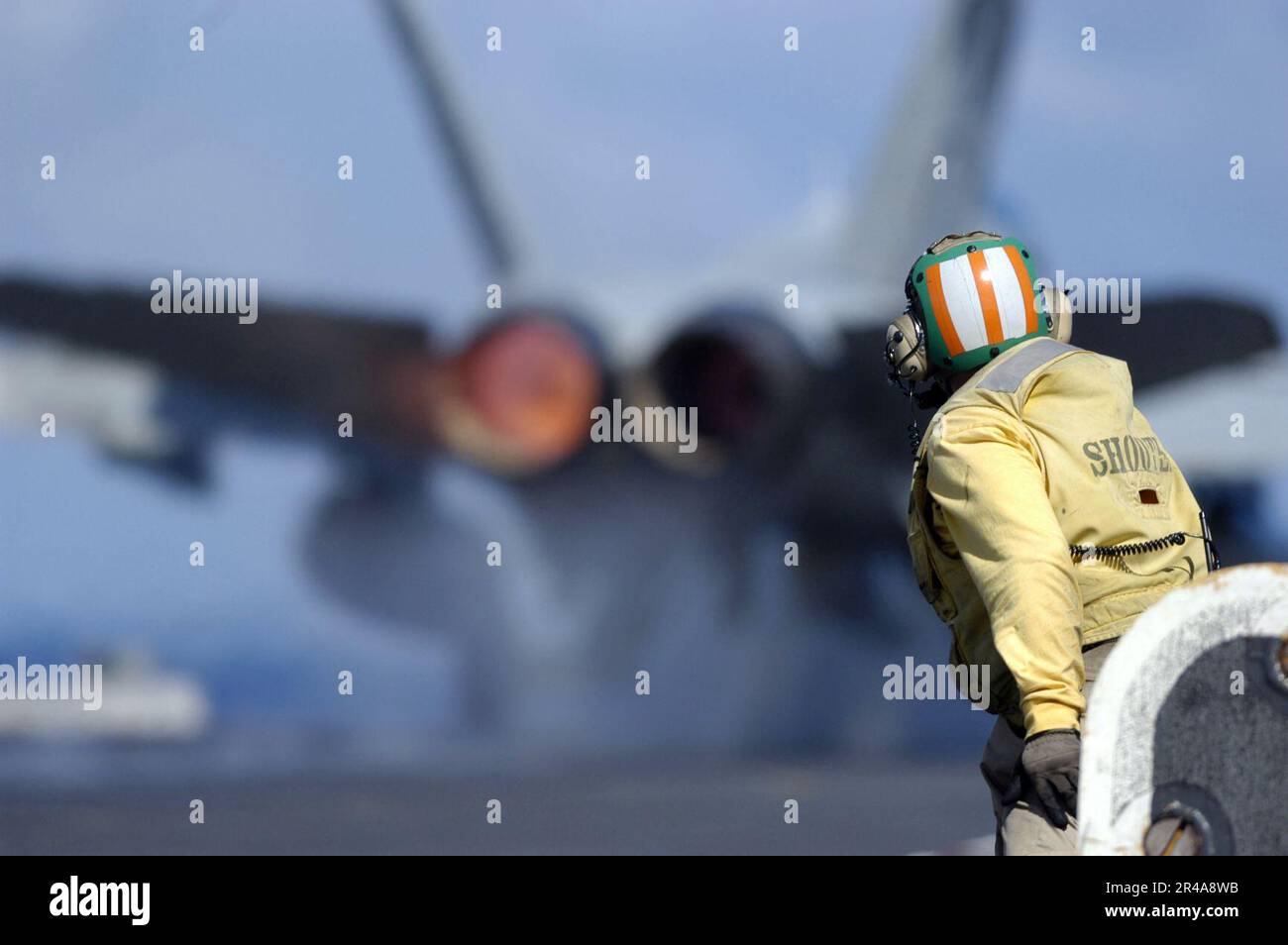 US Navy A catapult shooter launches an F-A-18C Hornet off the bow of ...