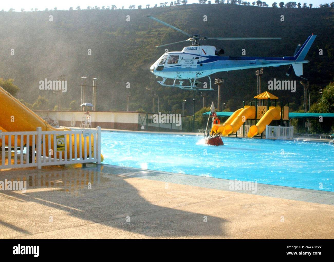 US Navy An Italian firefighting helicopter loads-up its 125-gallon bag ...