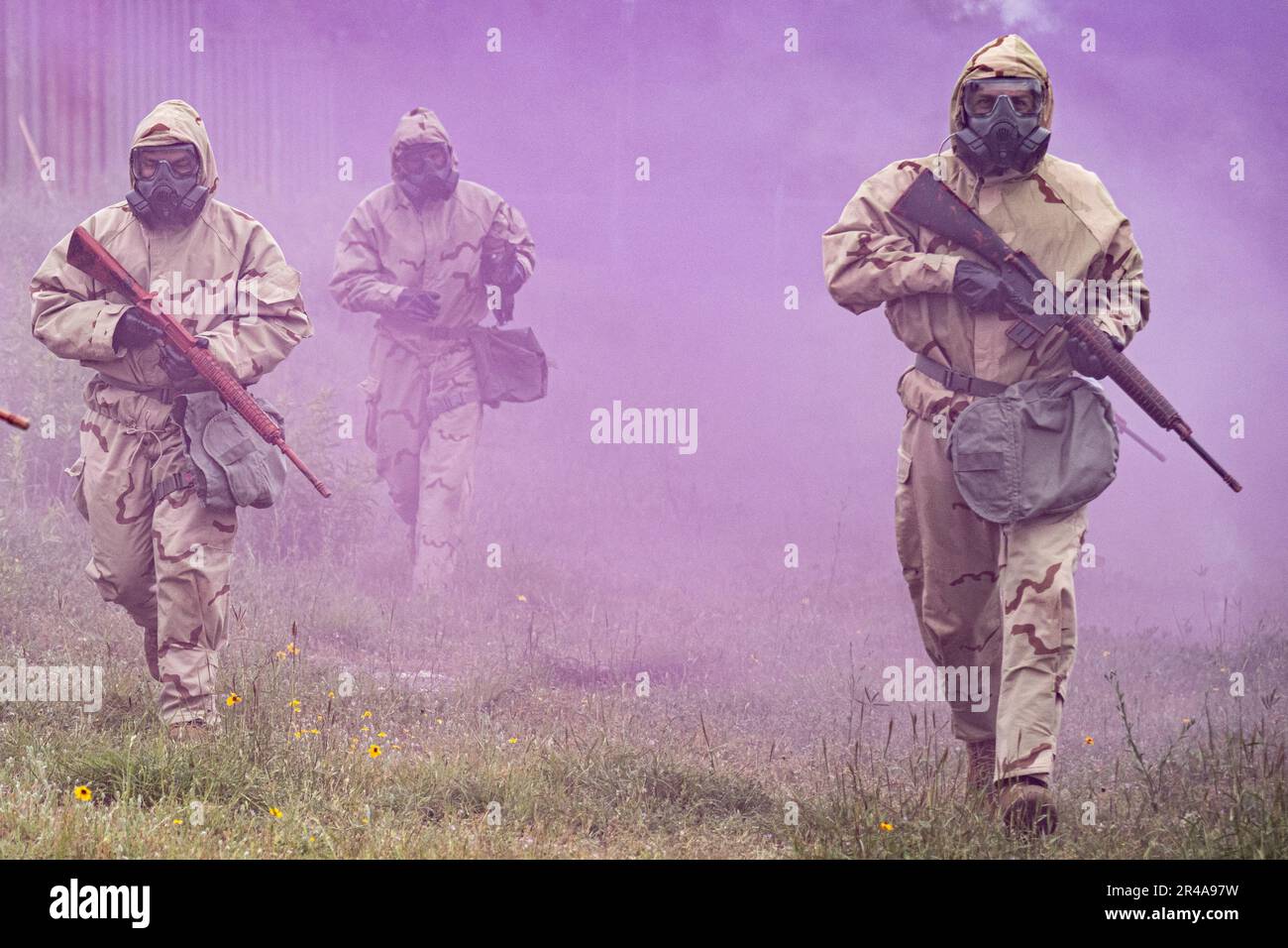 Soldiers wearing Mission Oriented Protective Posture (MOPP) gear run to ...