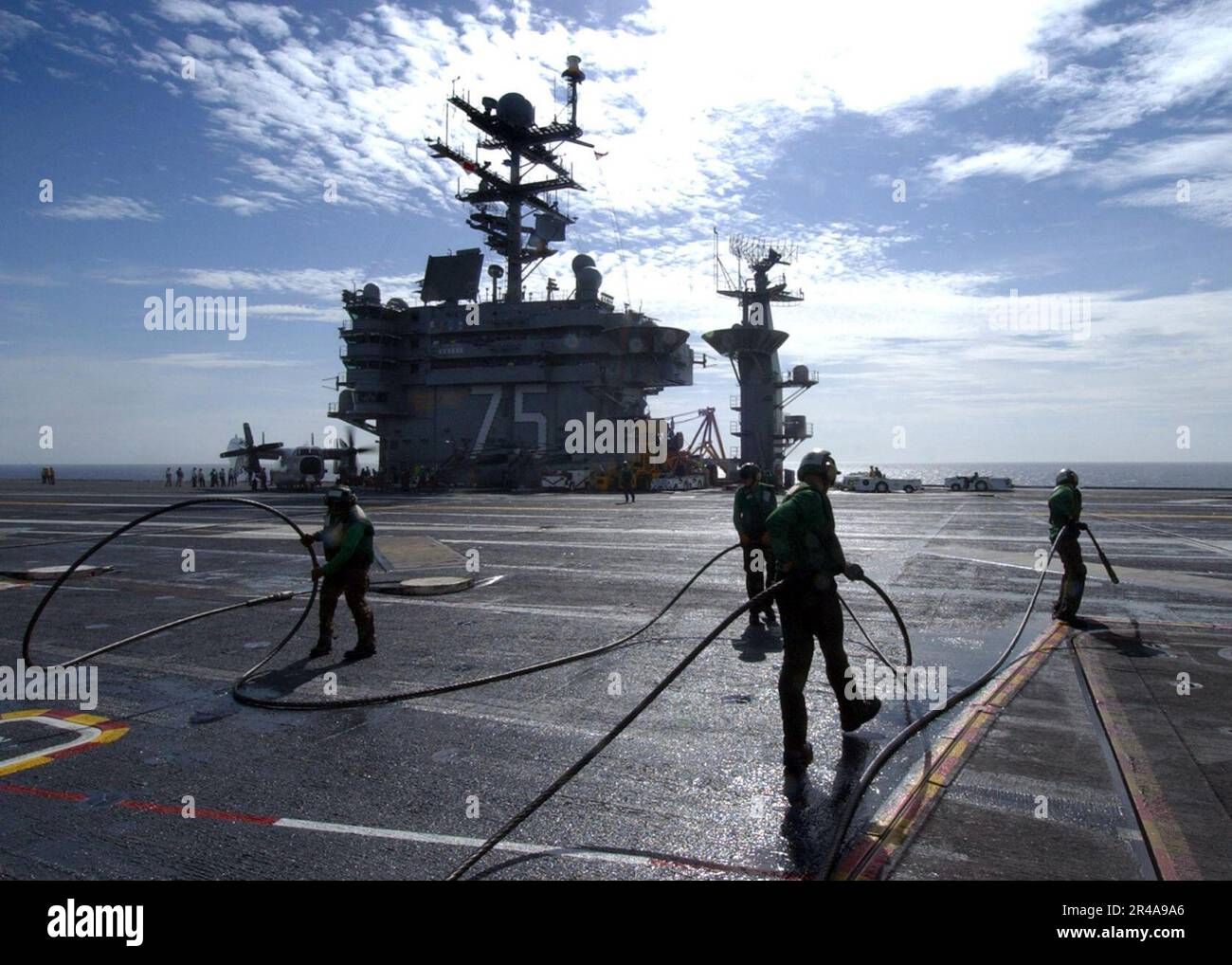 US Navy Sailors assigned to the V-2 Division reconnect the number three ...