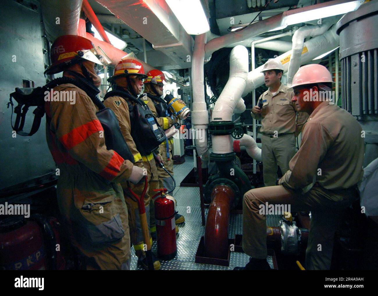 US Navy Sailors assigned to Repair Locker Three hose team aboard ...