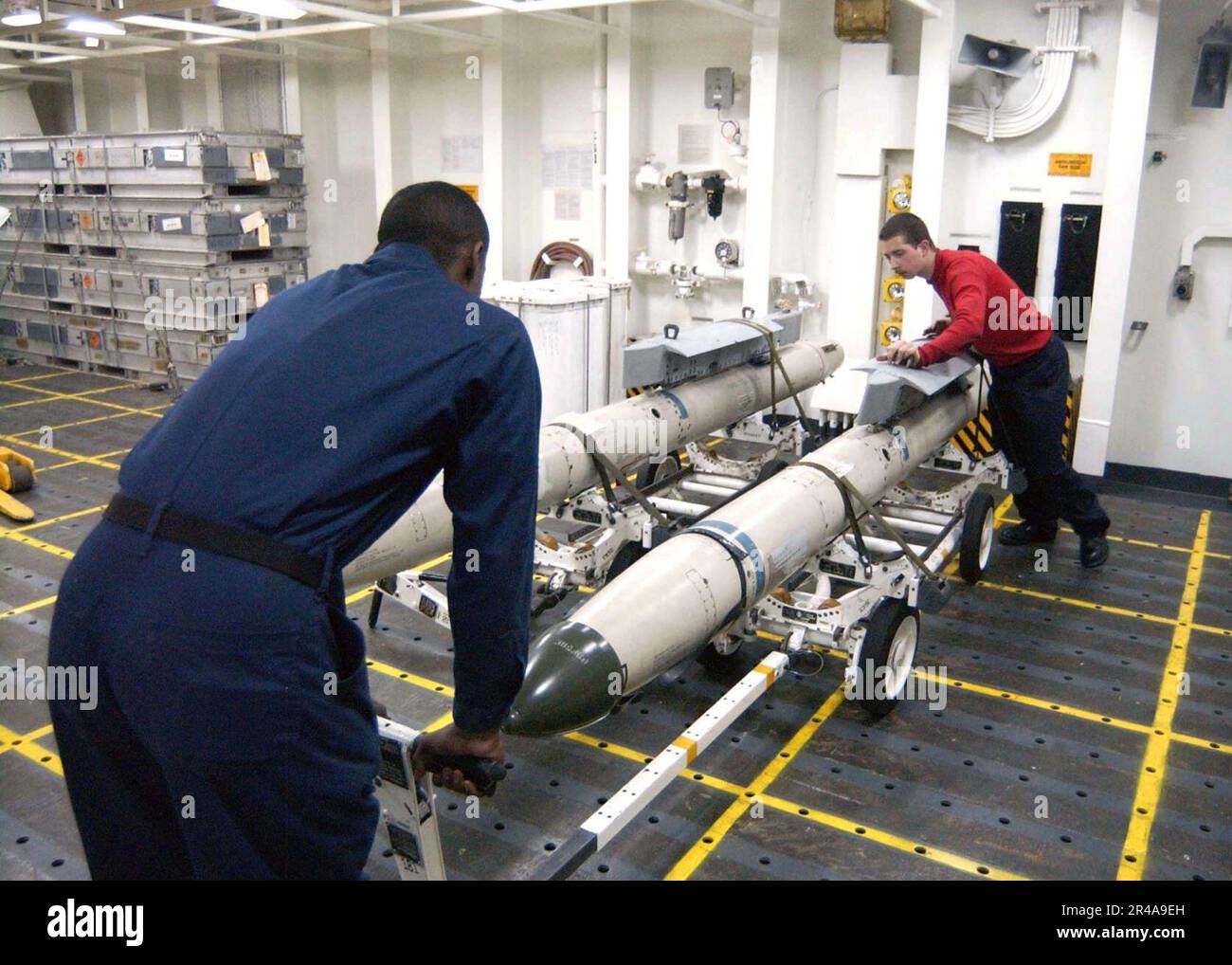 US Navy Aviation Ordnancemen assigned to the Weapons Department aboard ...
