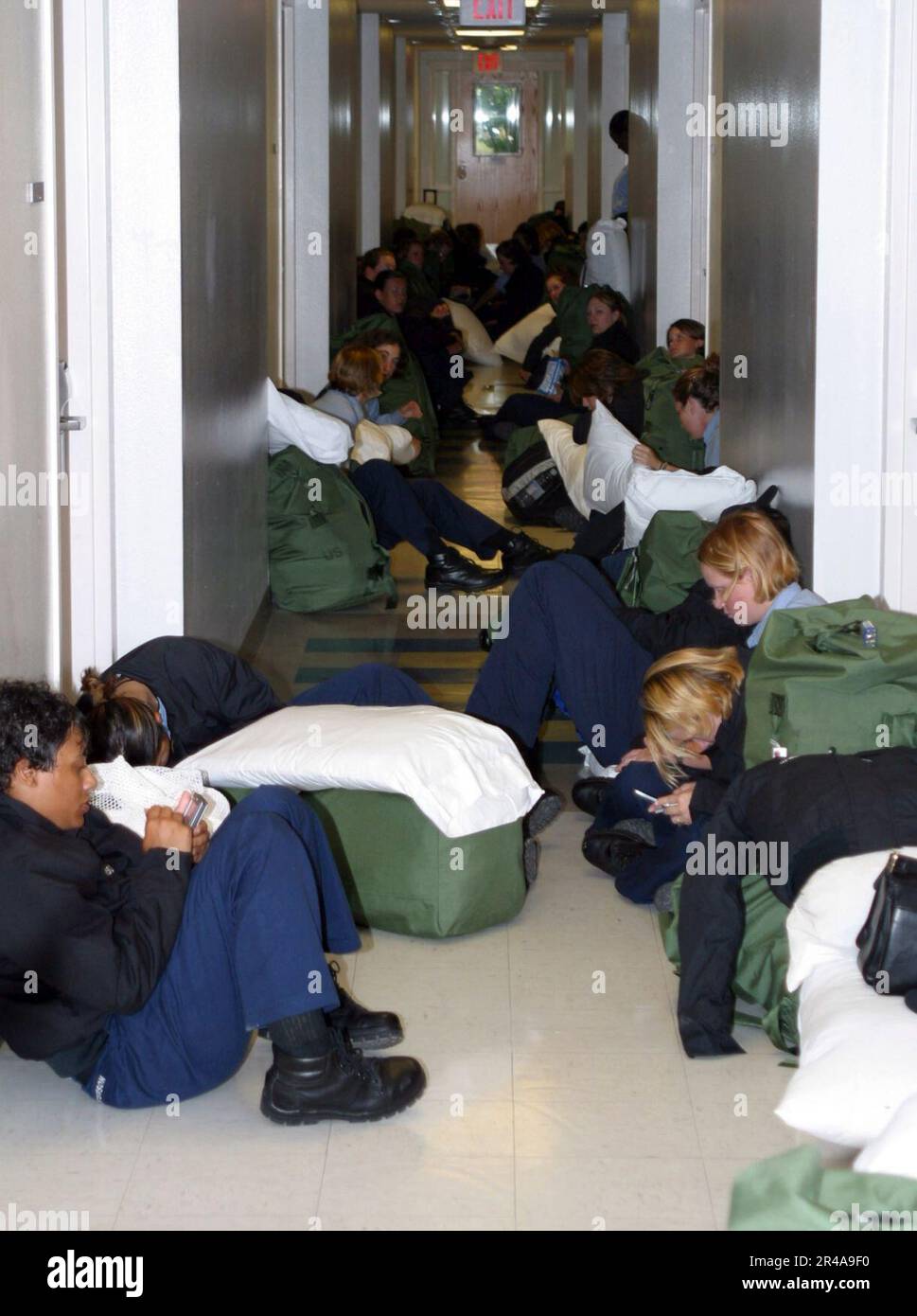 US Navy U.S. Navy students line the hall in a barracks while waiting to ...