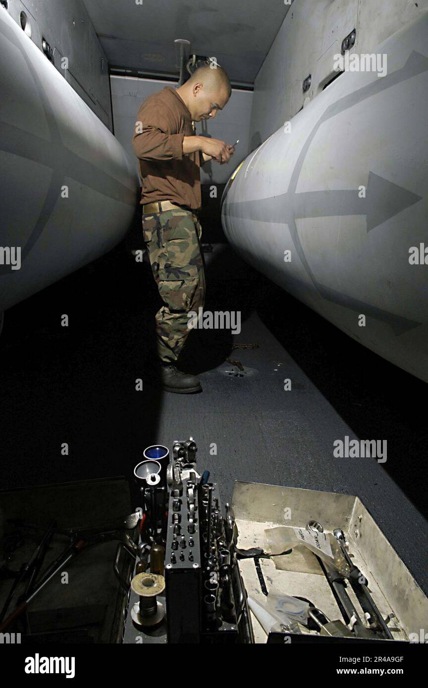 US Navy Sgt. works on one of the external fuel tanks of an F-A-18C ...