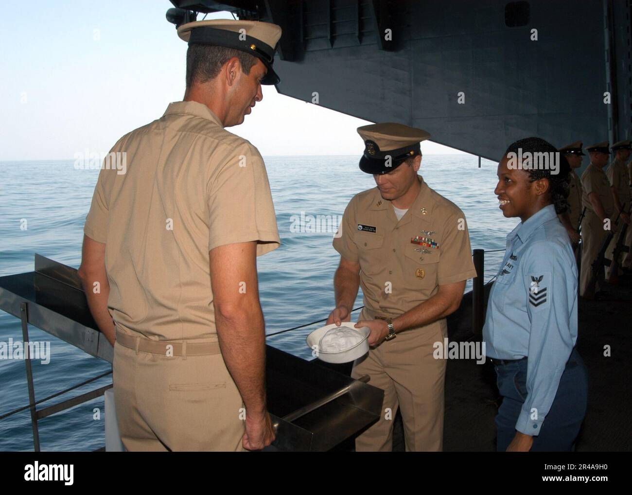 US Navy Information Systems Technician 1st Class right, looks on as ...
