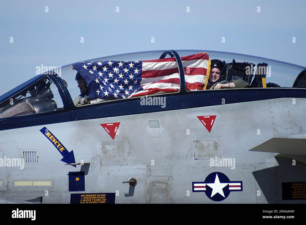 US Navy Pilots hold up the American Flag as they taxi their F-14D ...