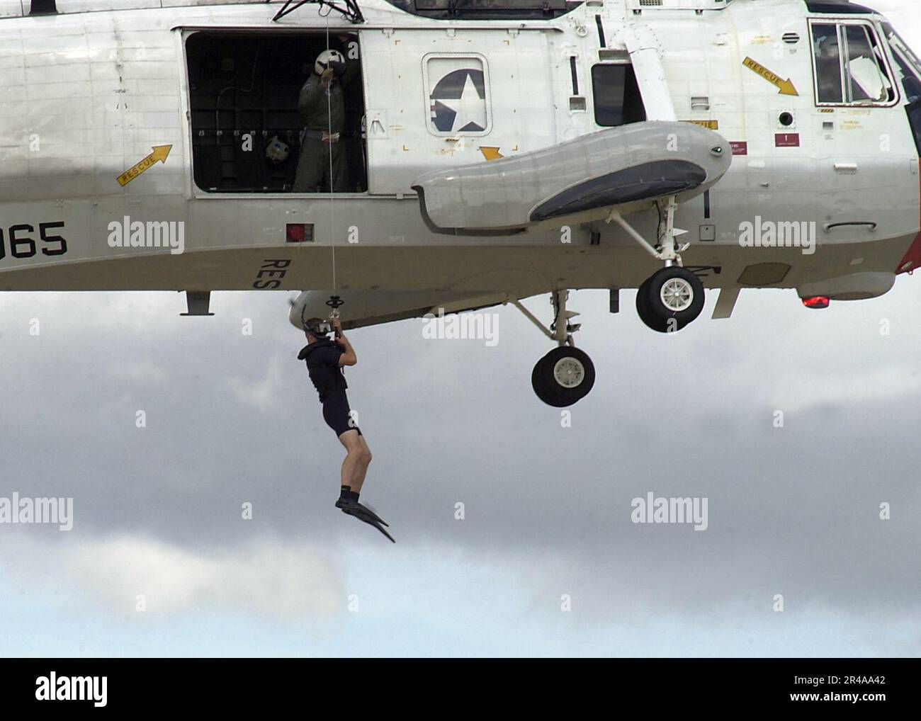 US Navy A search and rescue (SAR) swimmer demonstrates being lowered ...