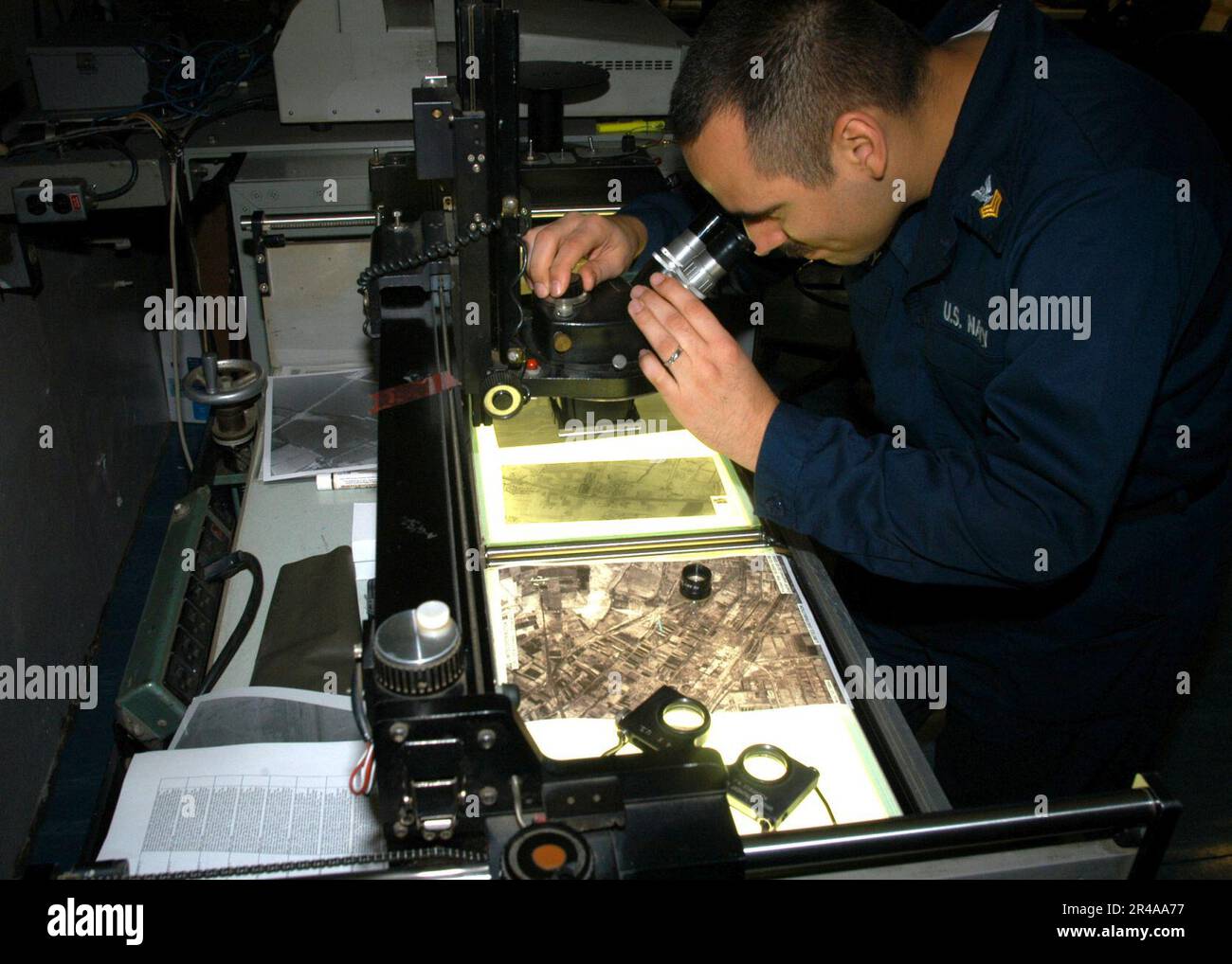 US Navy Intelligence Specialist 1st Class examines film from a Tactical ...