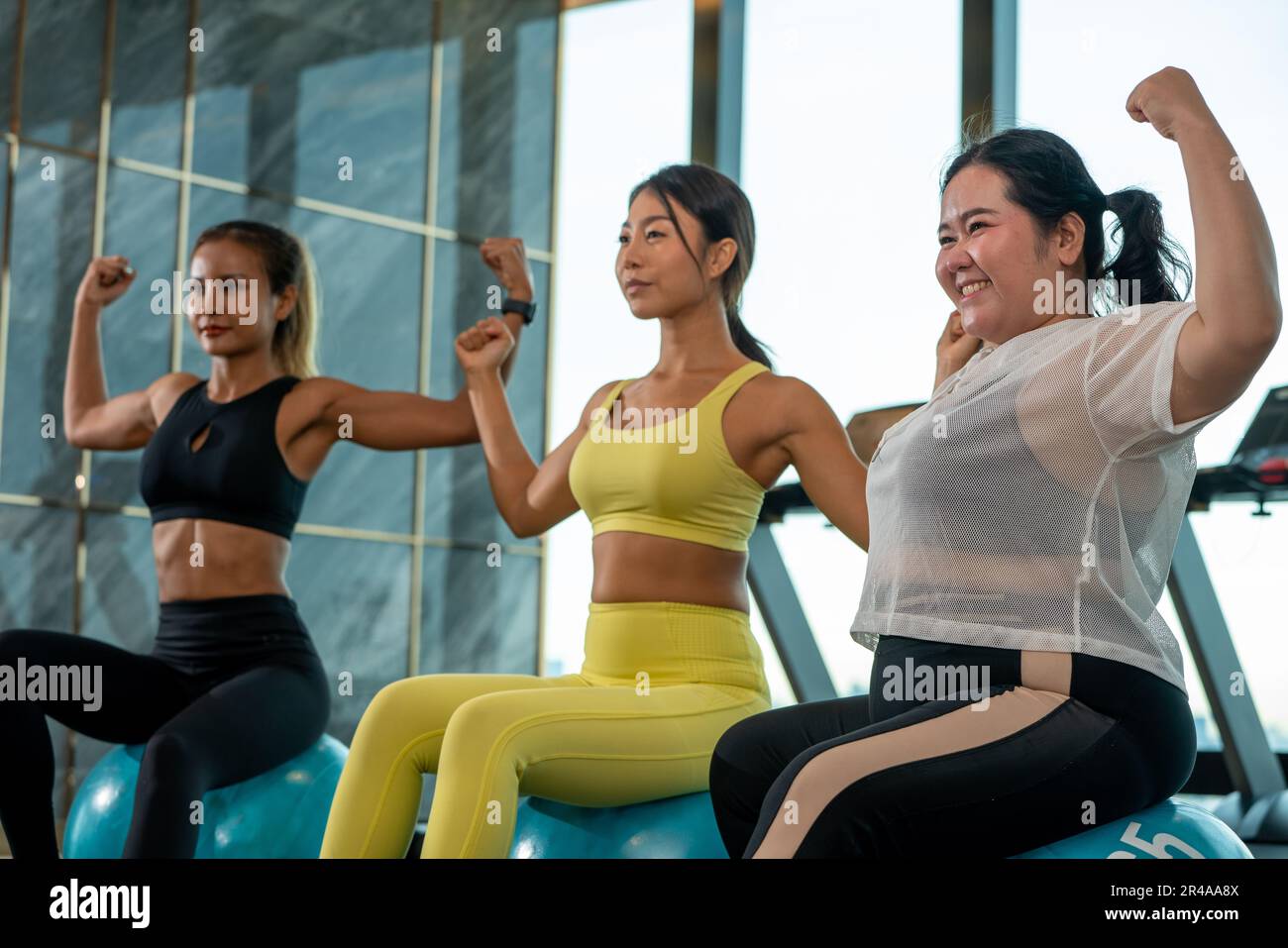 Humor in sports Ball Yoga. Fat Asian woman with her Yoga Instrutor ...