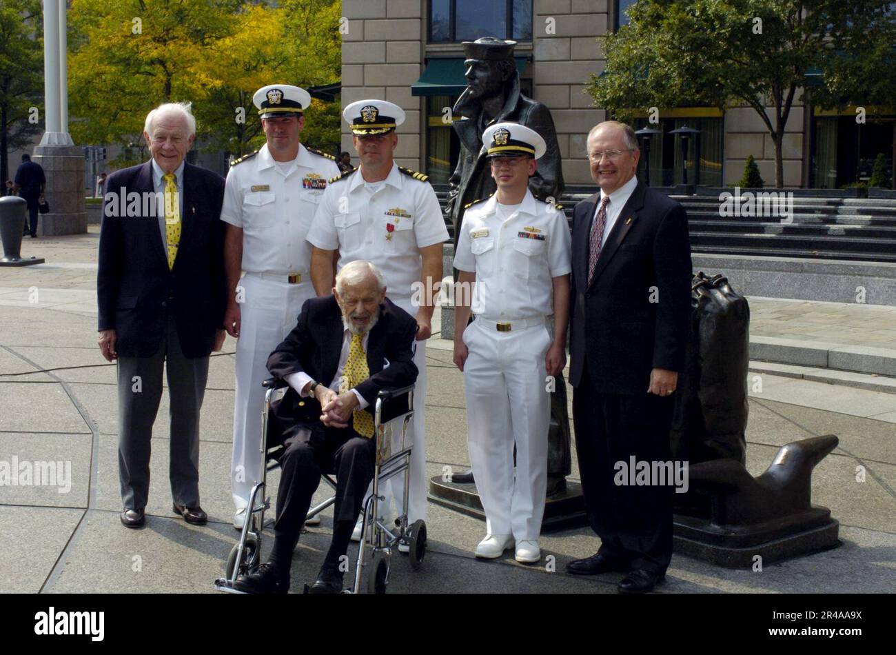 US Navy Cmdr. Michael Hegarty, center, stands with Former Secretary of ...