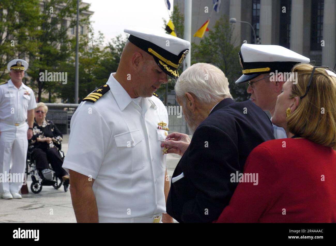 US Navy Ambassador and Former Secretary of the Navy Paul H. Nitze presents a Bronze Star to Cmdr ...