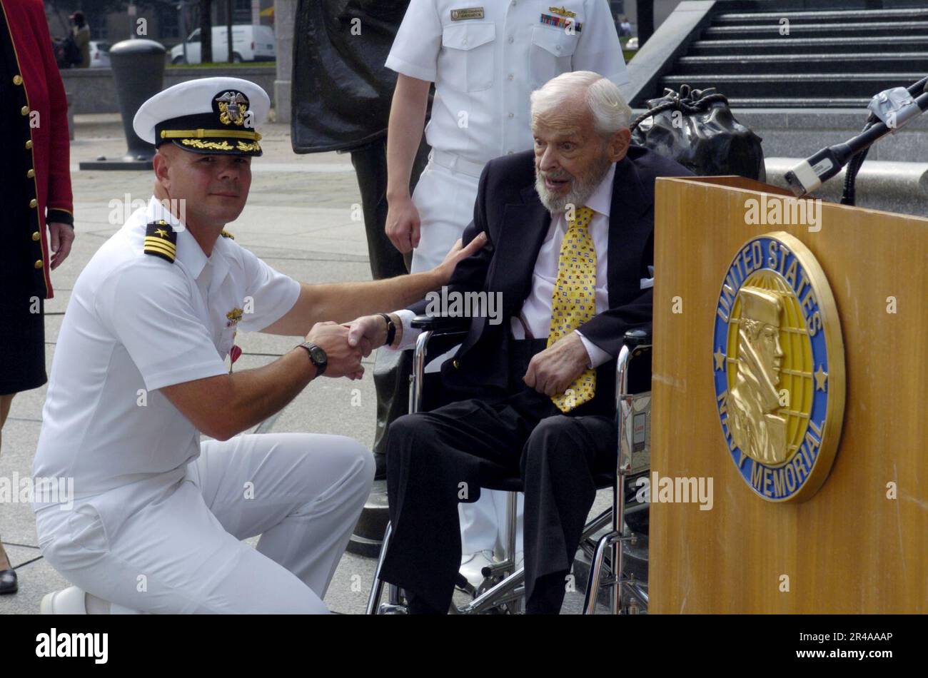 US Navy Cmdr. Michael Hegarty shakes the hand of Former Secretary of ...