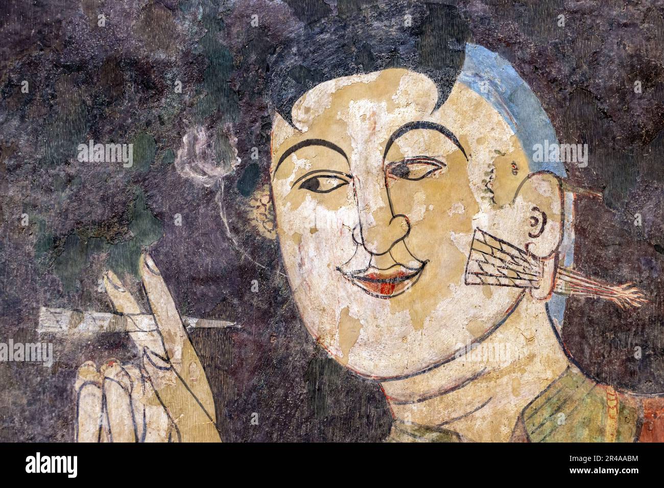 A man smokes a cigarette, mural painting from 19th century inside a ...