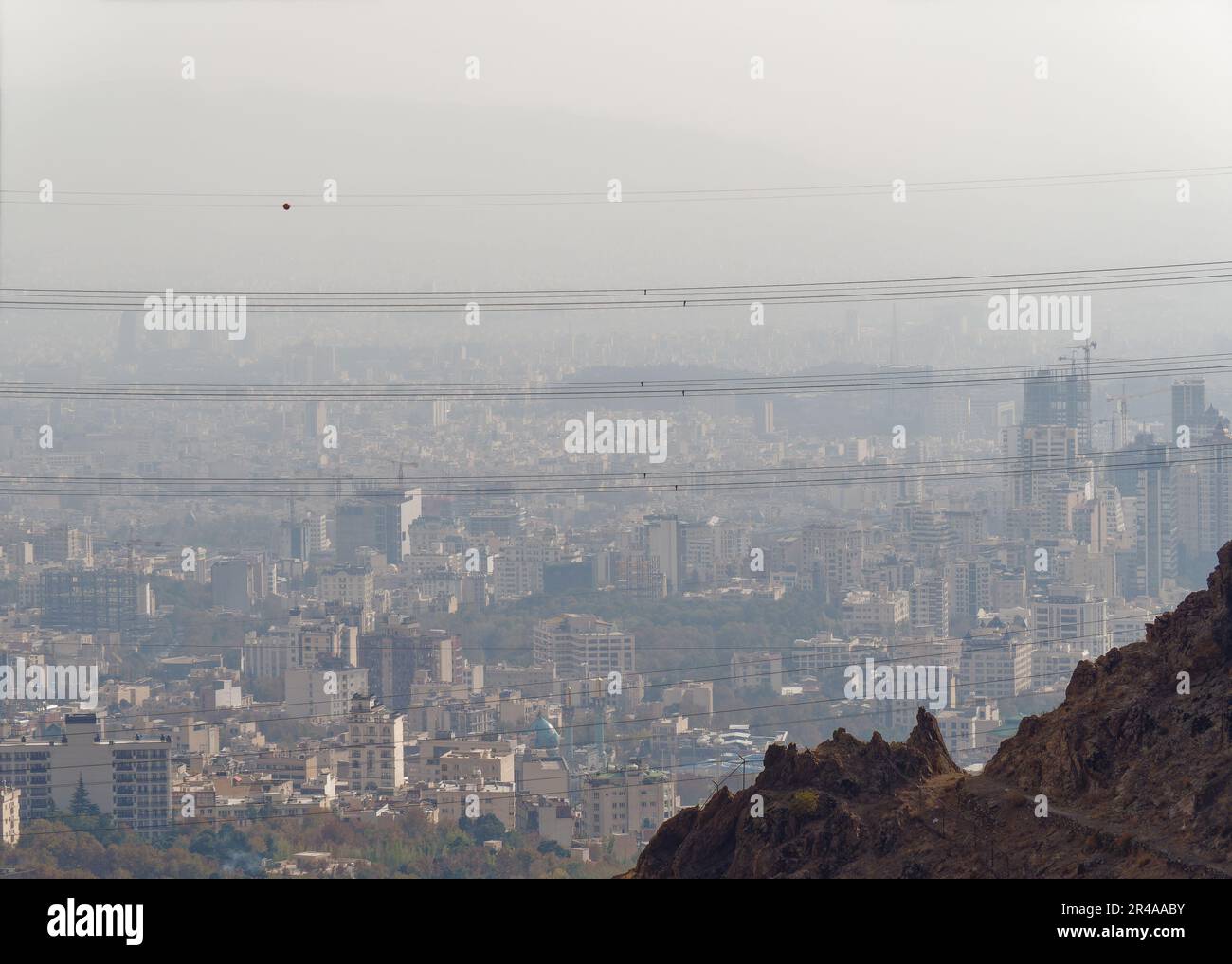 An aerial cityscape view of Tehran with multiple power lines ...