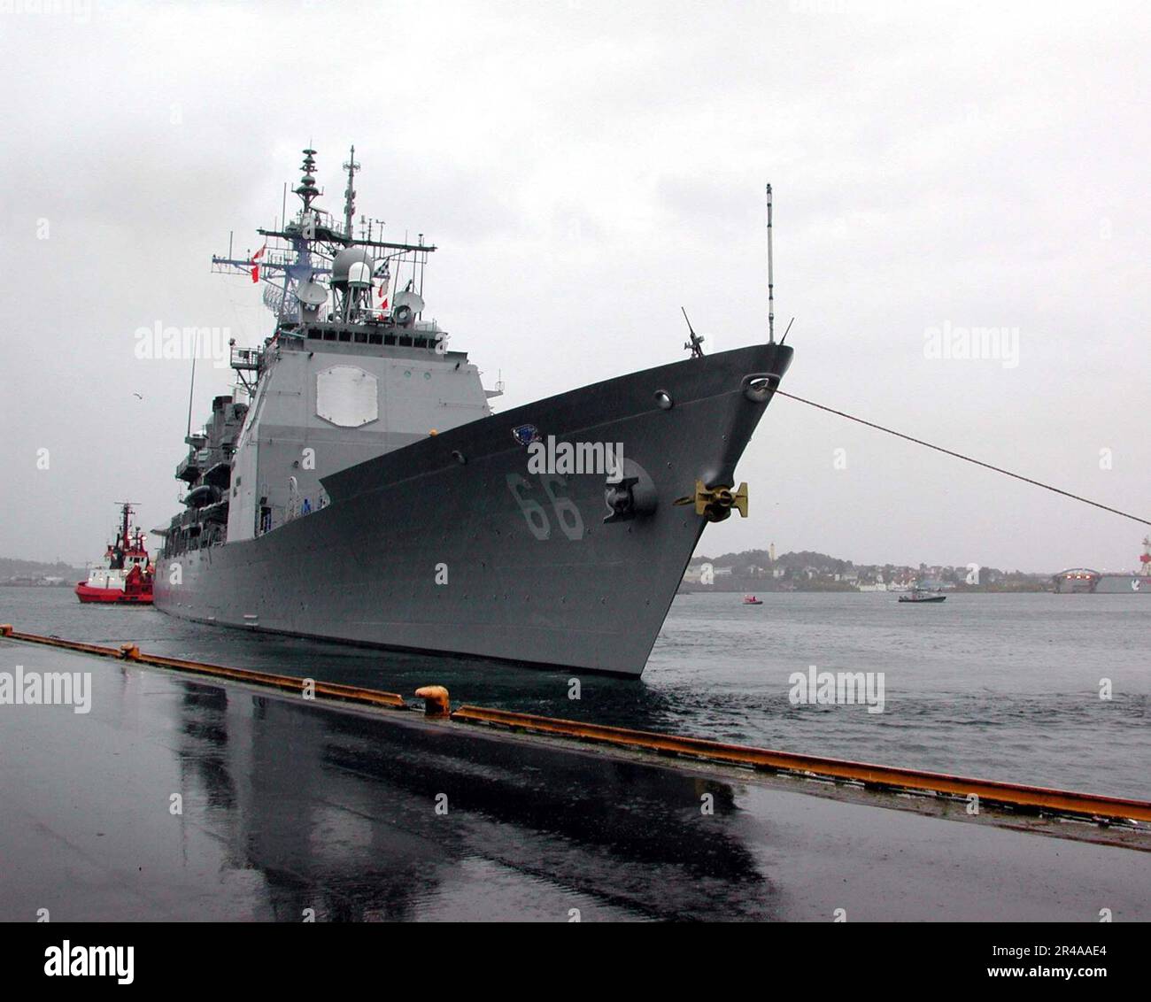 US Navy Tug boats assist the guided missile cruiser USS Hue City (CG 66 ...