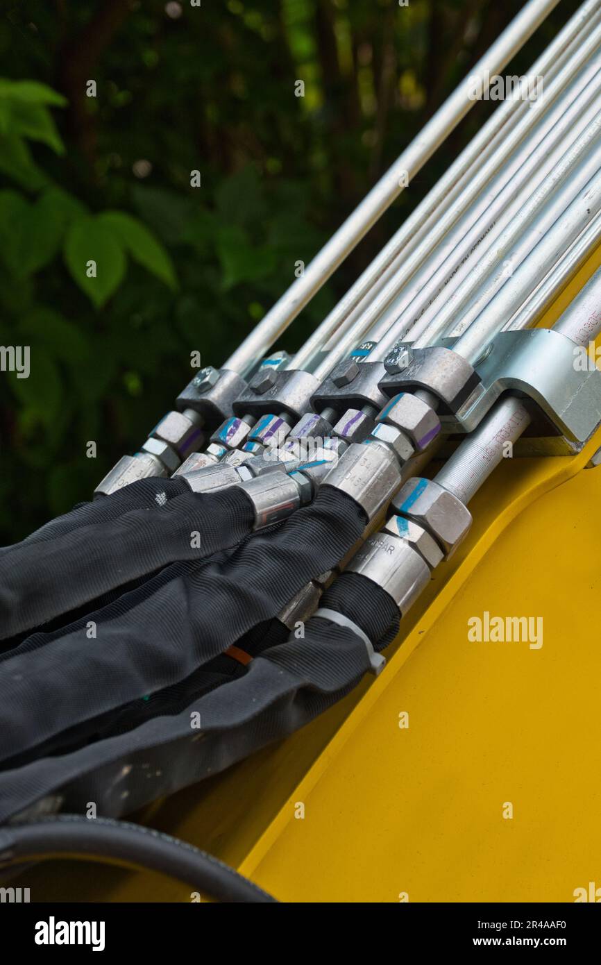 A close up of hydraulic lines and connections on an excavator Stock ...