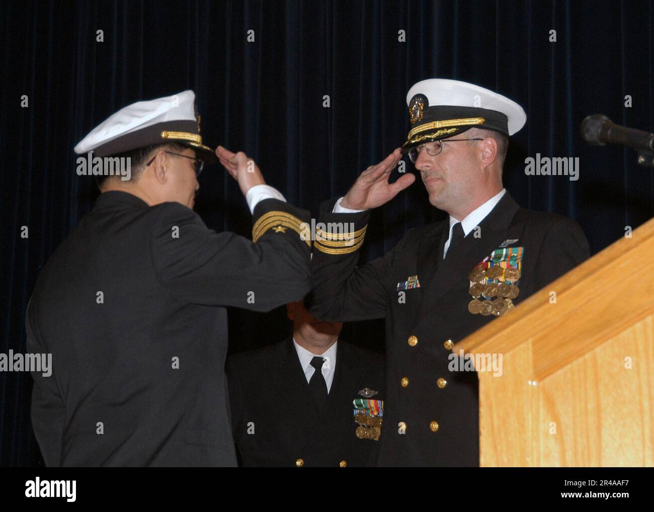 US Navy Commander Paul E. Erickson, right, assumes command of the ...