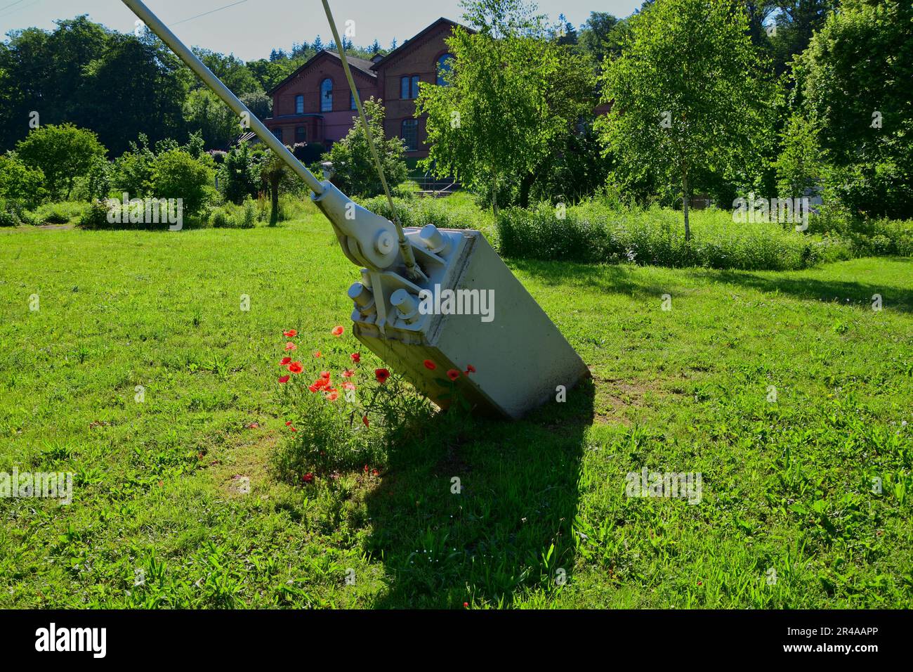 A steel cable foundation for a bridge in the center of a lush grassy ...
