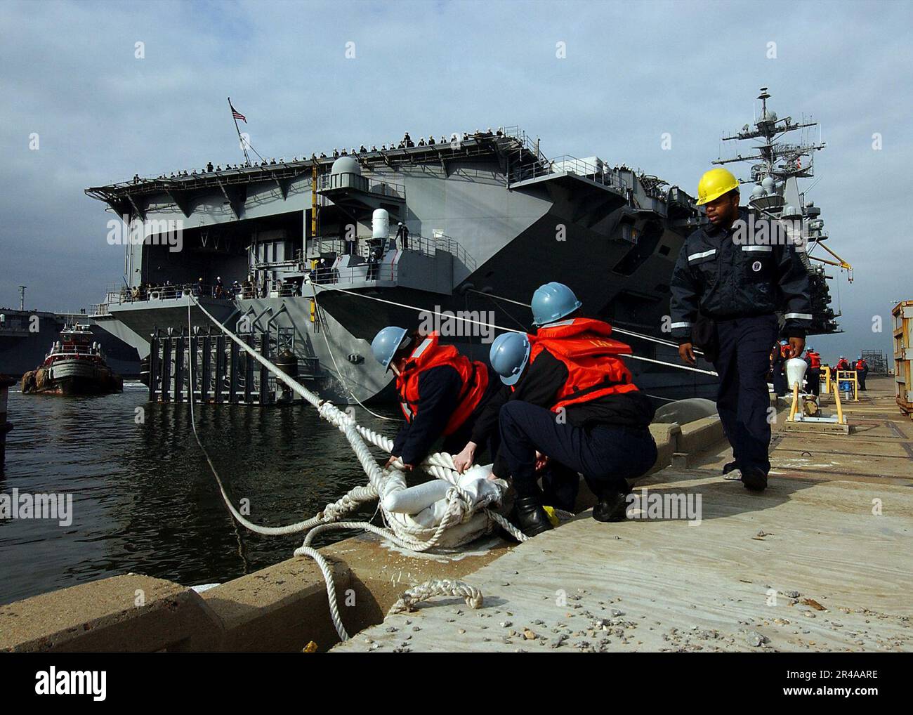 US Navy Line Handlers assigned to the Nimitz-class aircraft carrier USS ...