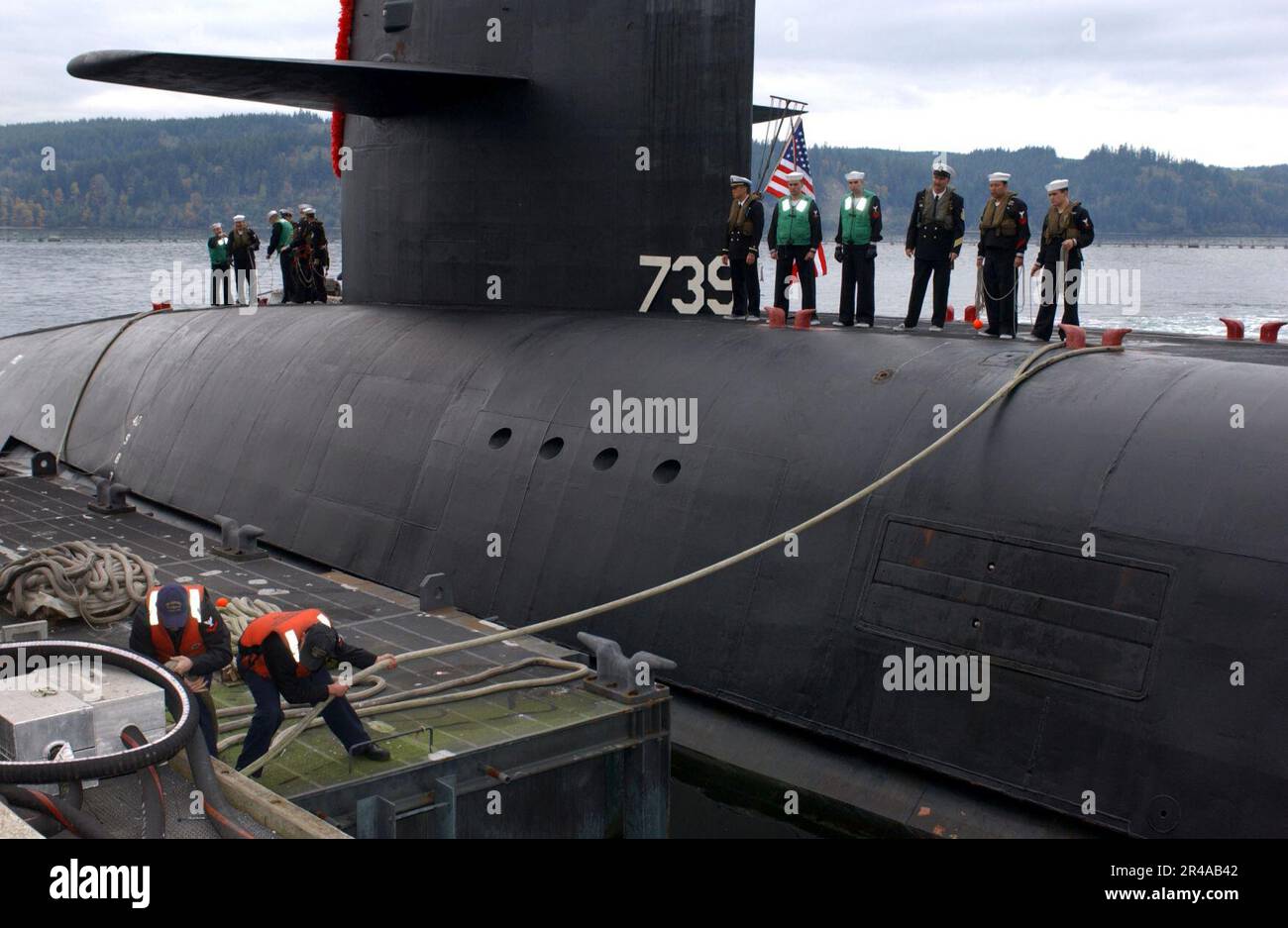 US Navy Crew members handle lines prior to mooring the Ohio-class fleet ...