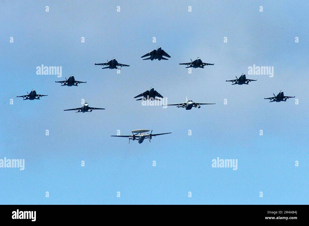 US Navy Aircraft assigned to Carrier Air Wing Fourteen (CVW-14) fly in formation above the ...