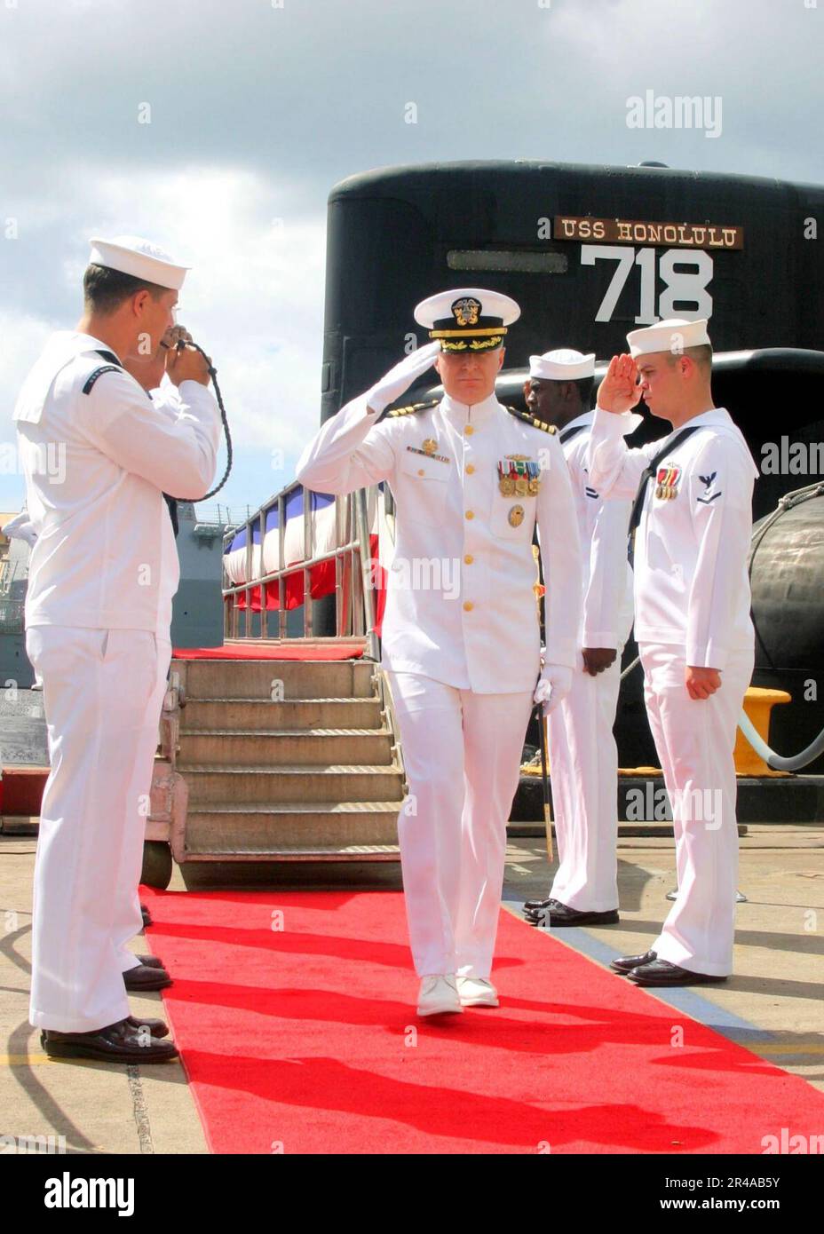 US Navy Cmdr. John Russ is piped ashore after assuming command of the ...