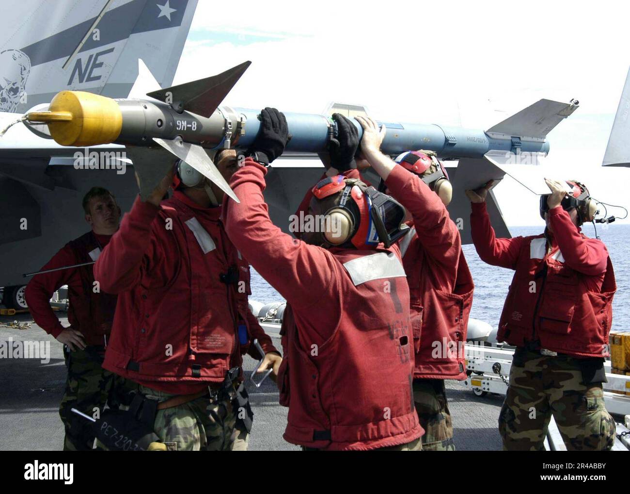 US Navy Aviation Ordnancemen load an inert Captive Air Training Missile ...