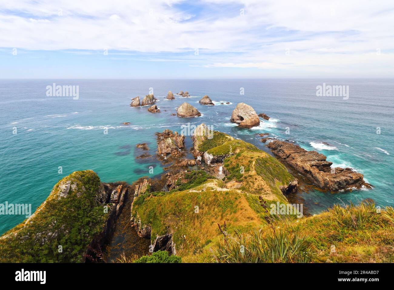 An aerial view of a rocky coastline with a deep blue ocean in the ...